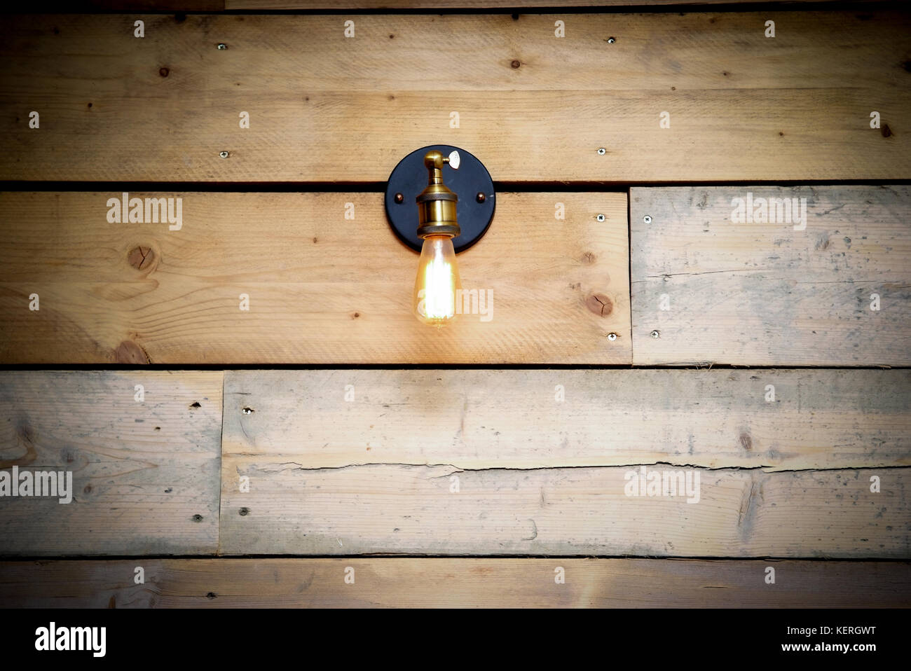 Spot light on a wooden interior wall with dark vignette Stock Photo - Alamy
