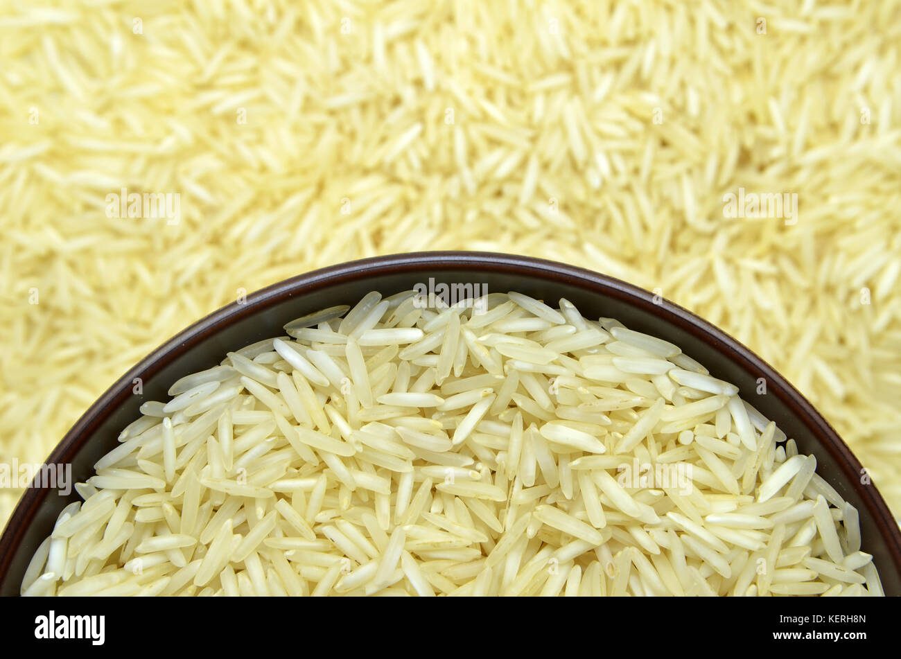 White basmati rice with wooden bowl. Close up Stock Photo - Alamy