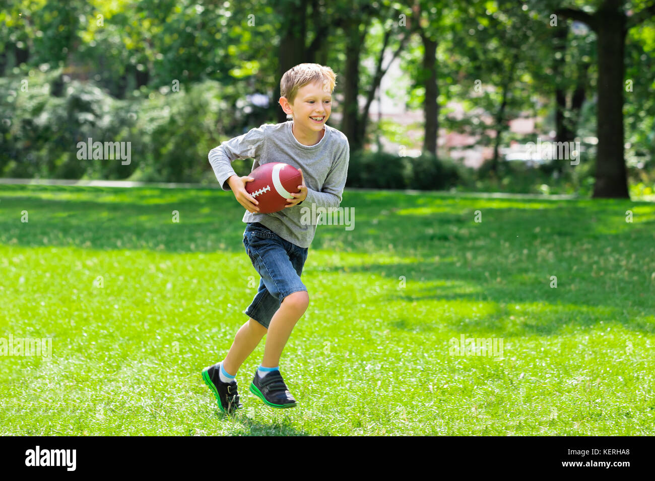 Boy holding rugby ball hi-res stock photography and images - Alamy