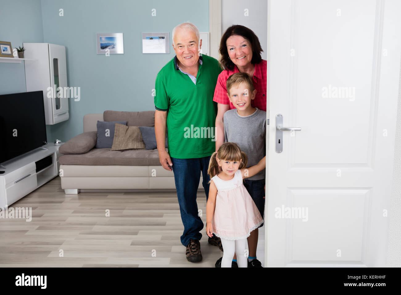 Woman standing behind door hi-res stock photography and images - Alamy