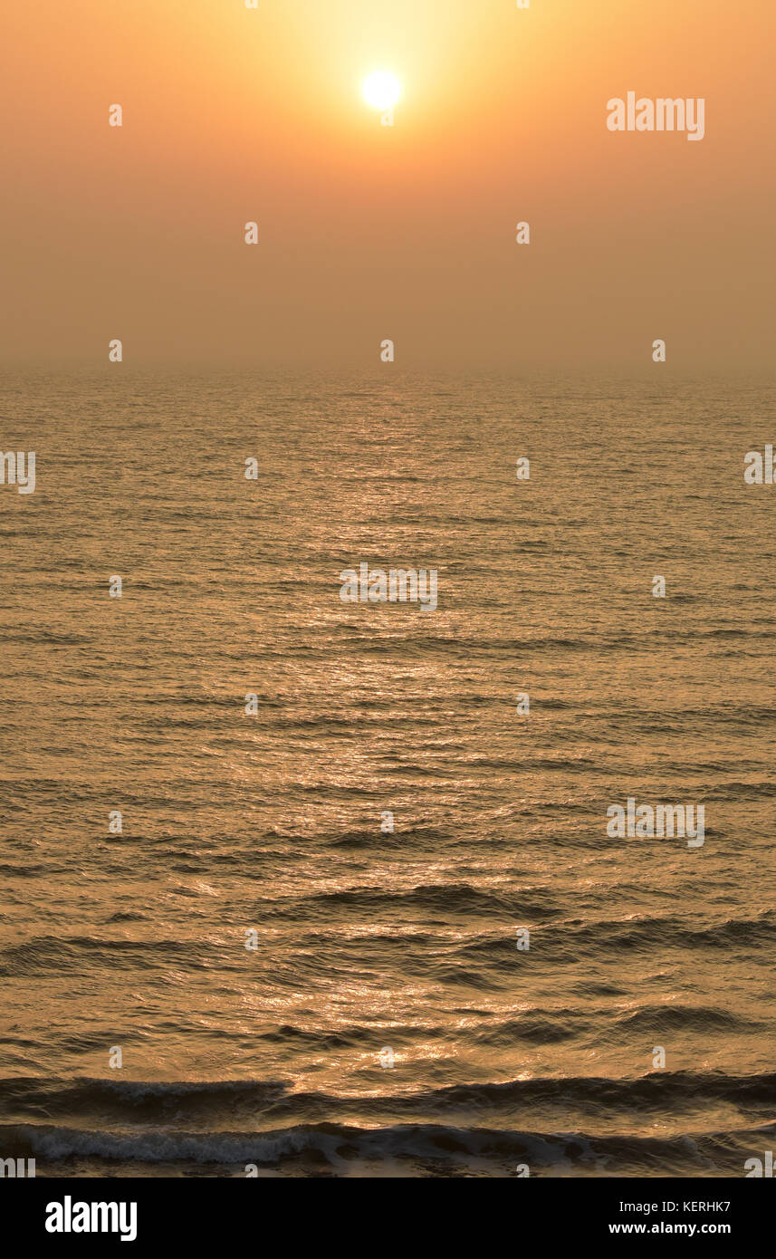 a golden and glowing sunset over the sea or ocean and the light ...