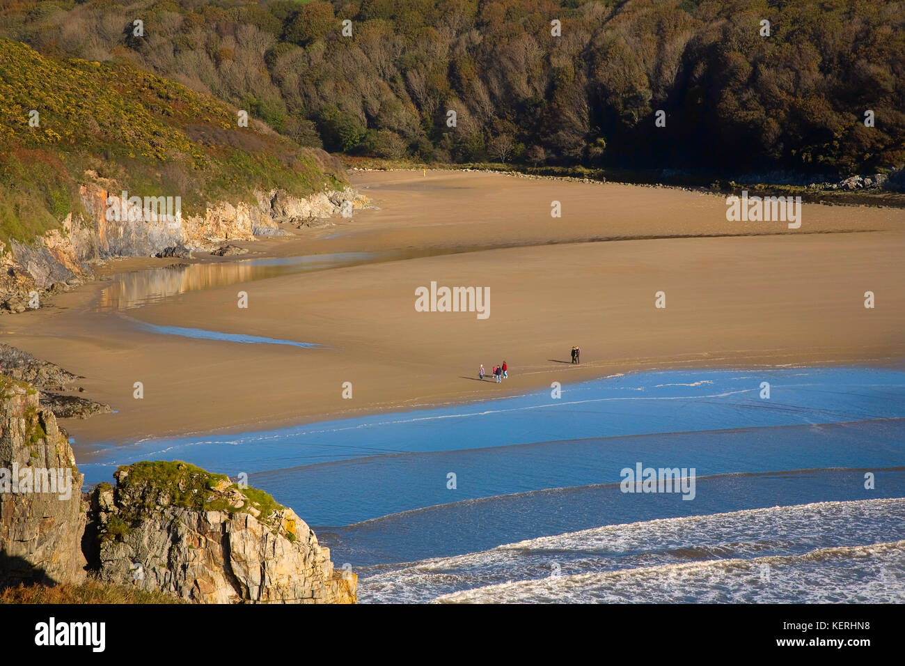 Walkers on Stradbally Cove, The Copper Coast, County Waterford, Ireland ...
