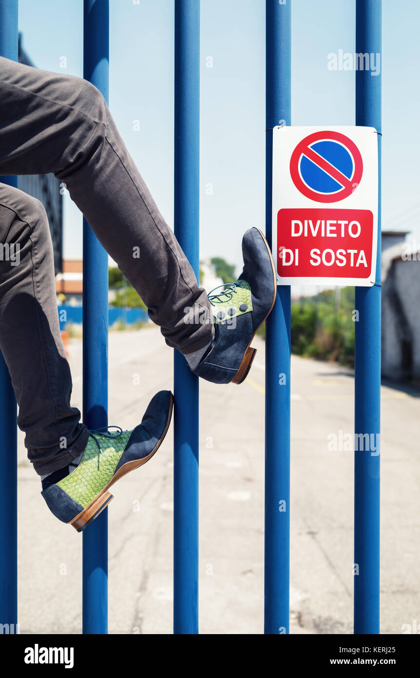 Detail of feet crossing a blue gate Stock Photo - Alamy