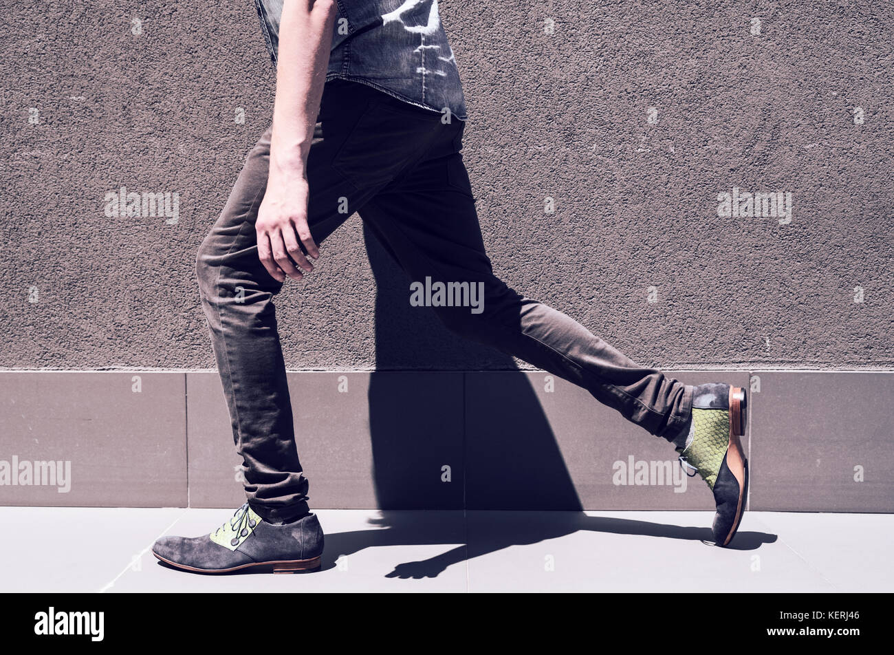 Young man walk and jump. There are shadows Stock Photo - Alamy