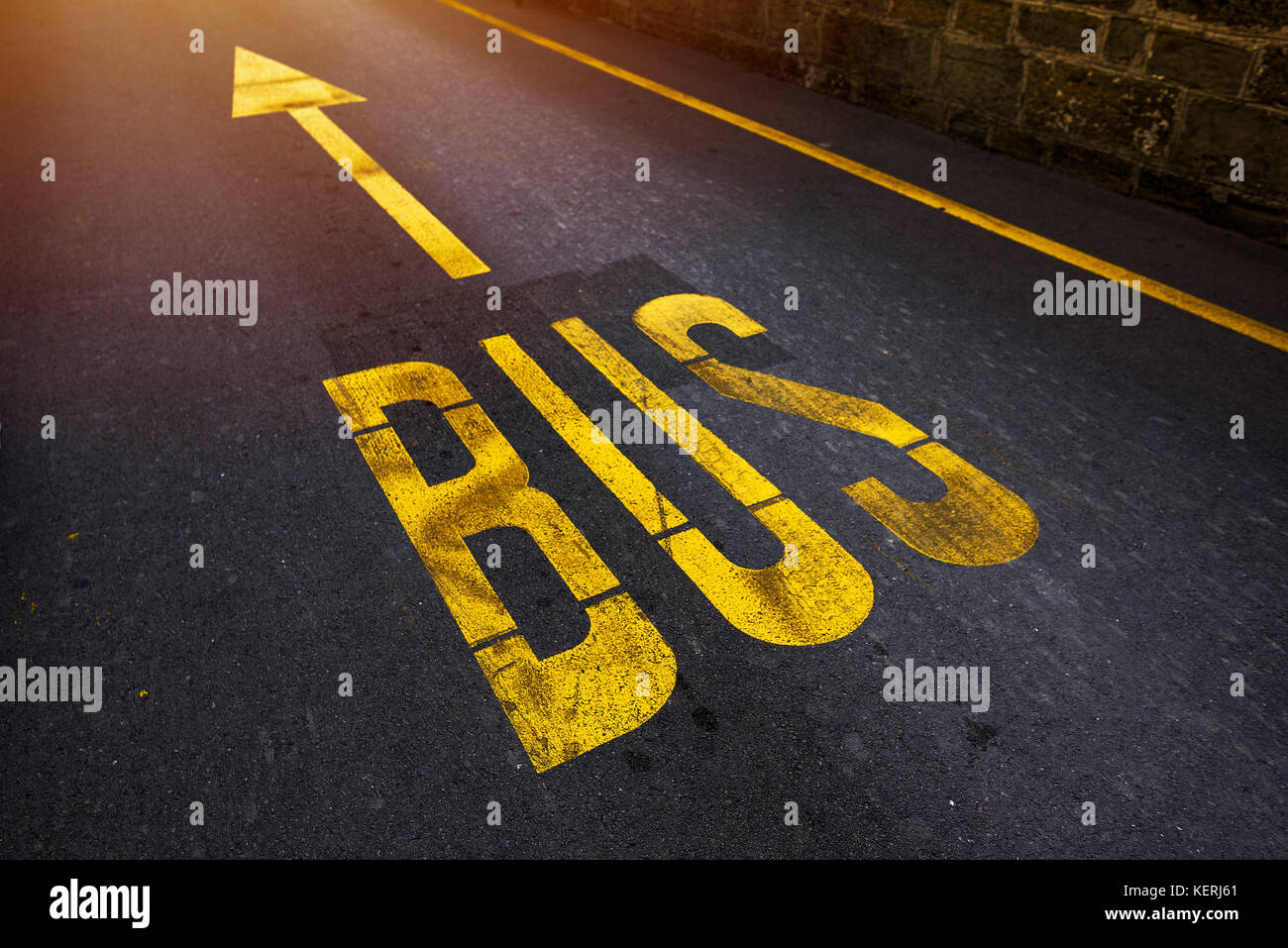 Bus lane, yellow sign with arrow on asphalt road Stock Photo - Alamy