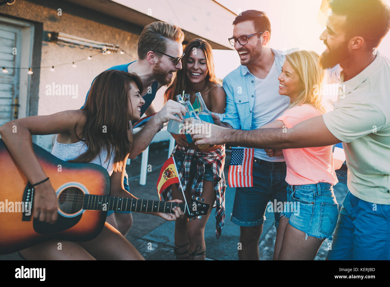 Group of happy friends having party on rooftop Stock Photo - Alamy