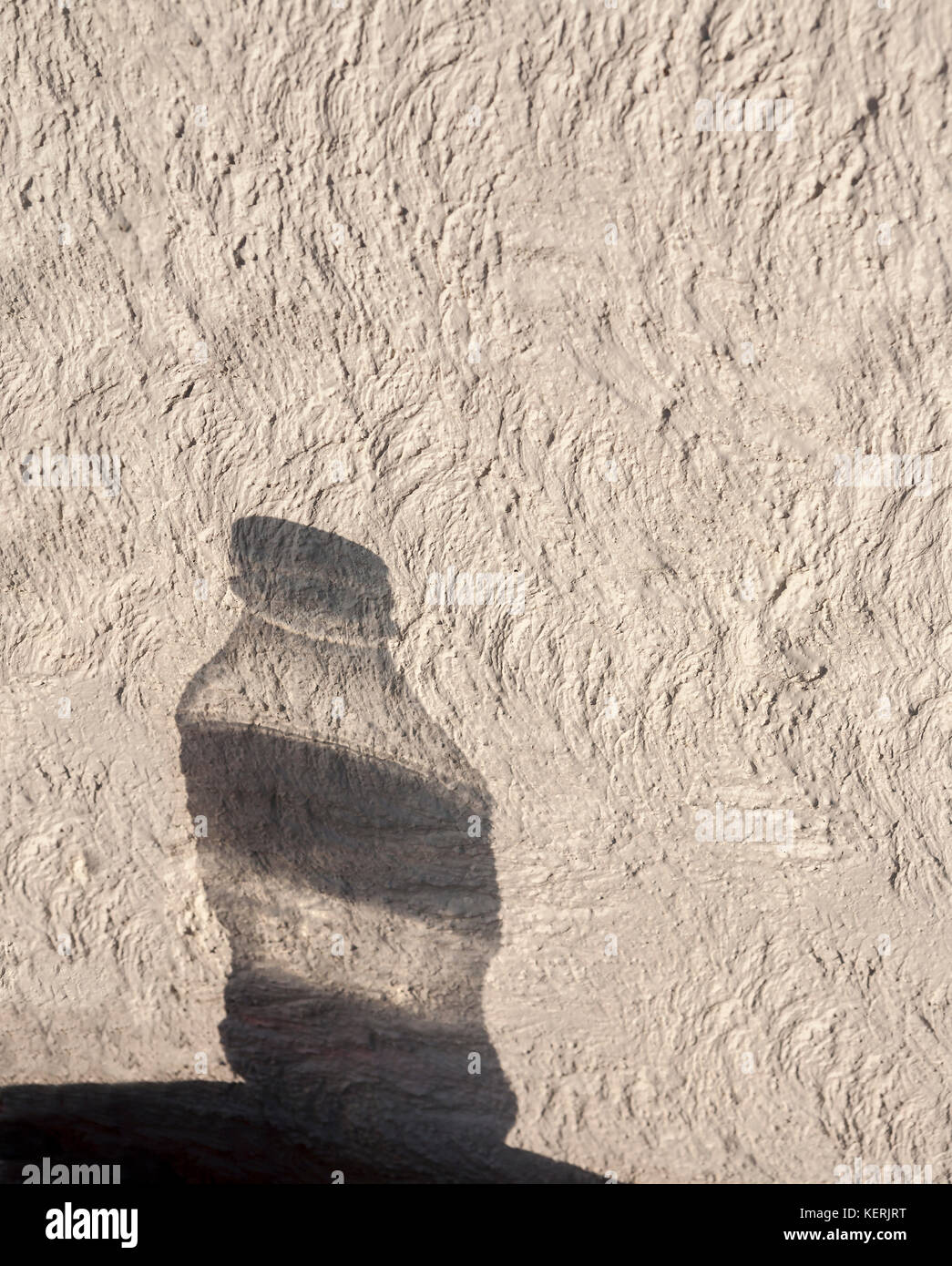 Shadow of a Coca-Cola bottle on a textured wall Stock Photo - Alamy