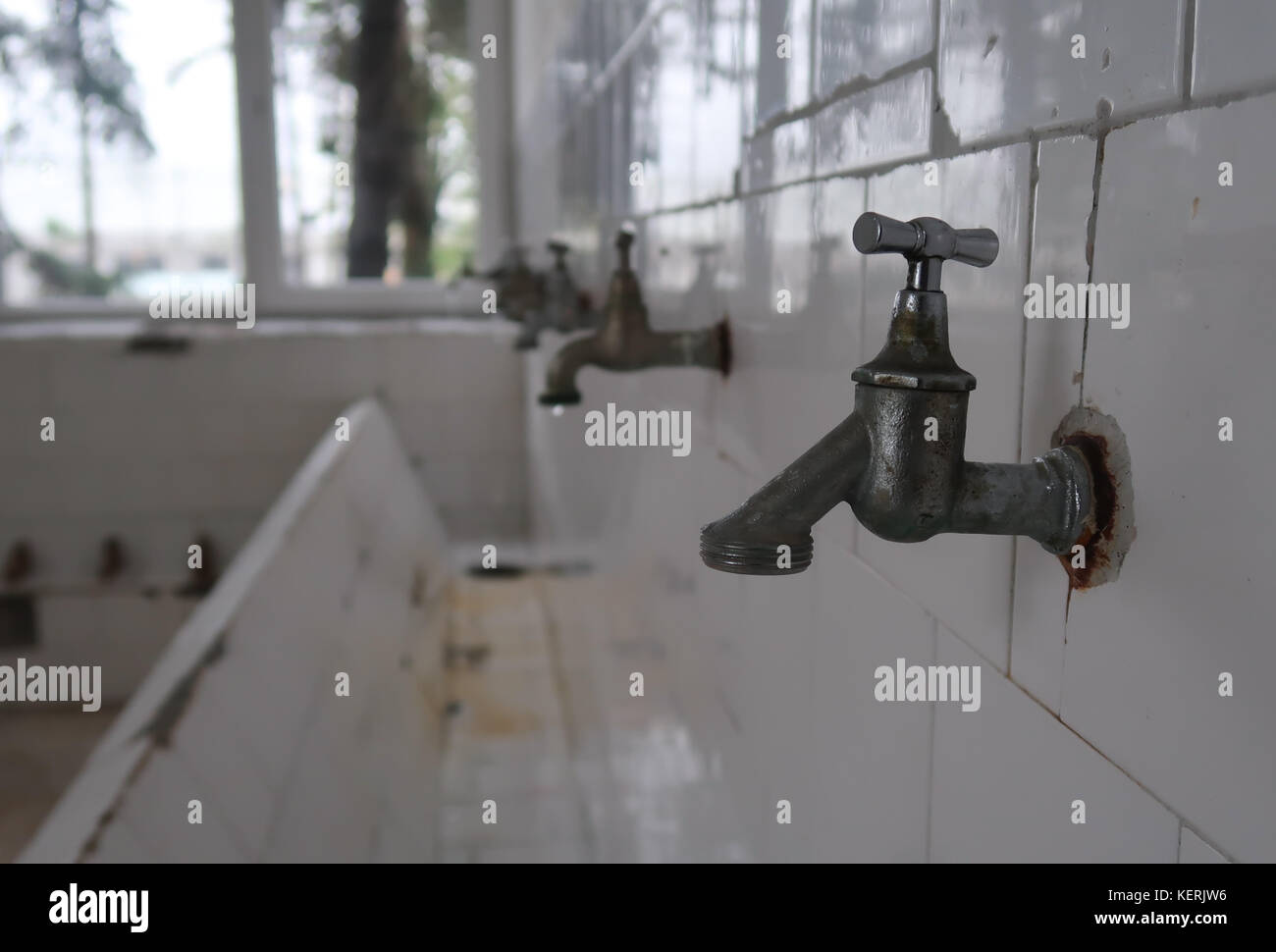 Old taps in a public toilet Stock Photo - Alamy
