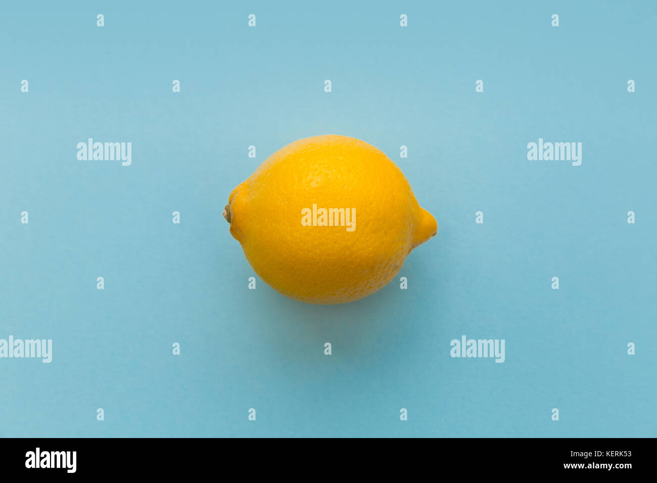 Yellow lemon fruit overhead on bright blue background Stock Photo - Alamy
