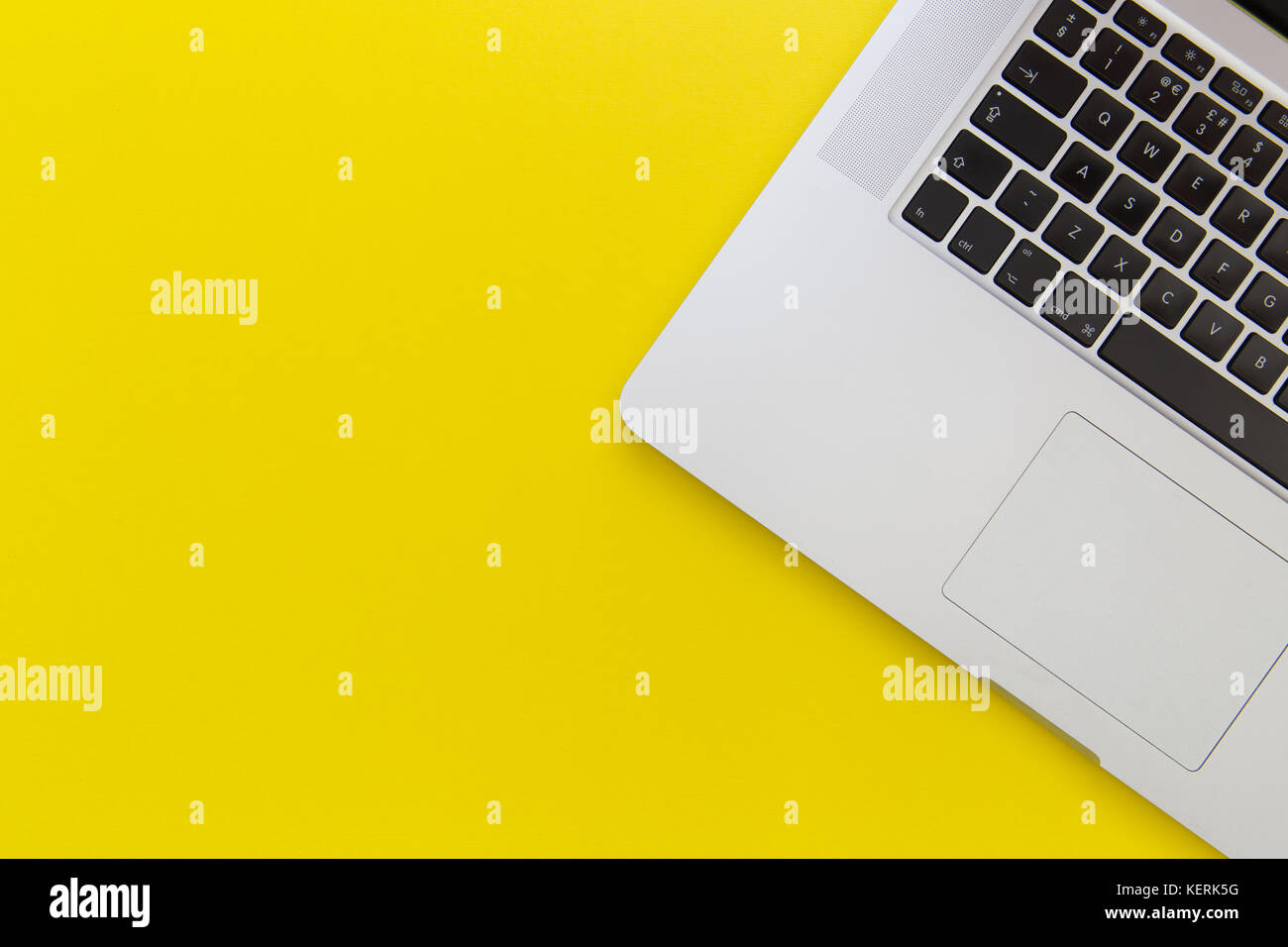 Office laptop computer on bright yellow background Stock Photo - Alamy