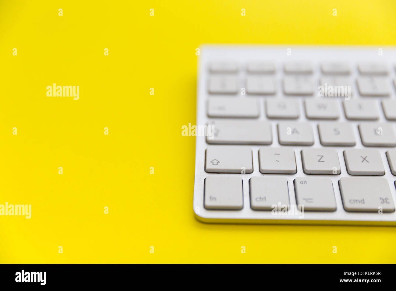 Wireless computer keyboard on bright colourful yellow background Stock ...