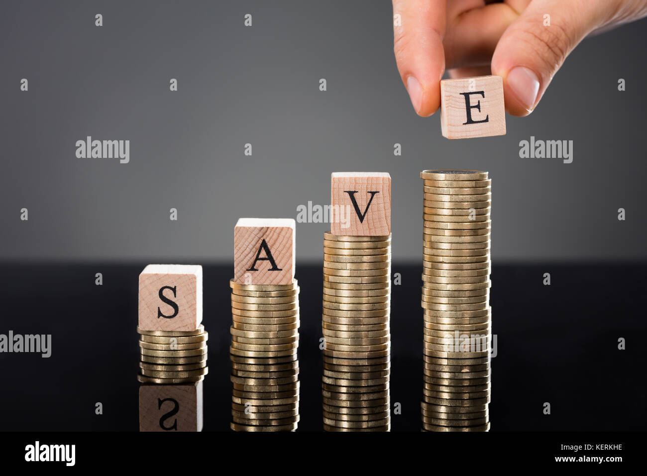 Person Hands Putting Save Word Letters On Stack Of Coins Over Gray ...