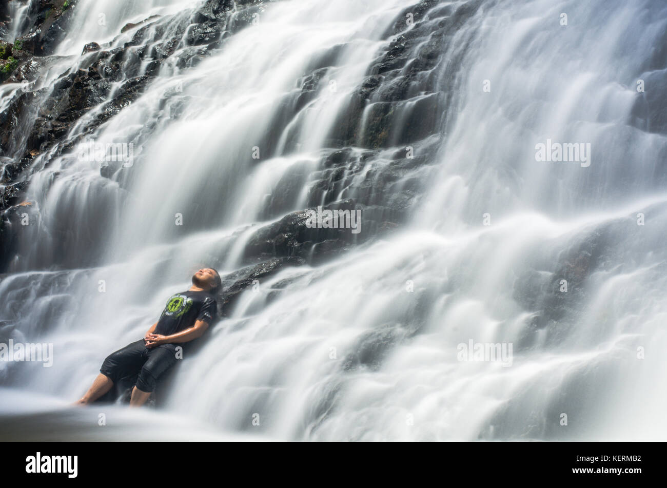 A guy taking his time at waterfall Stock Photo - Alamy