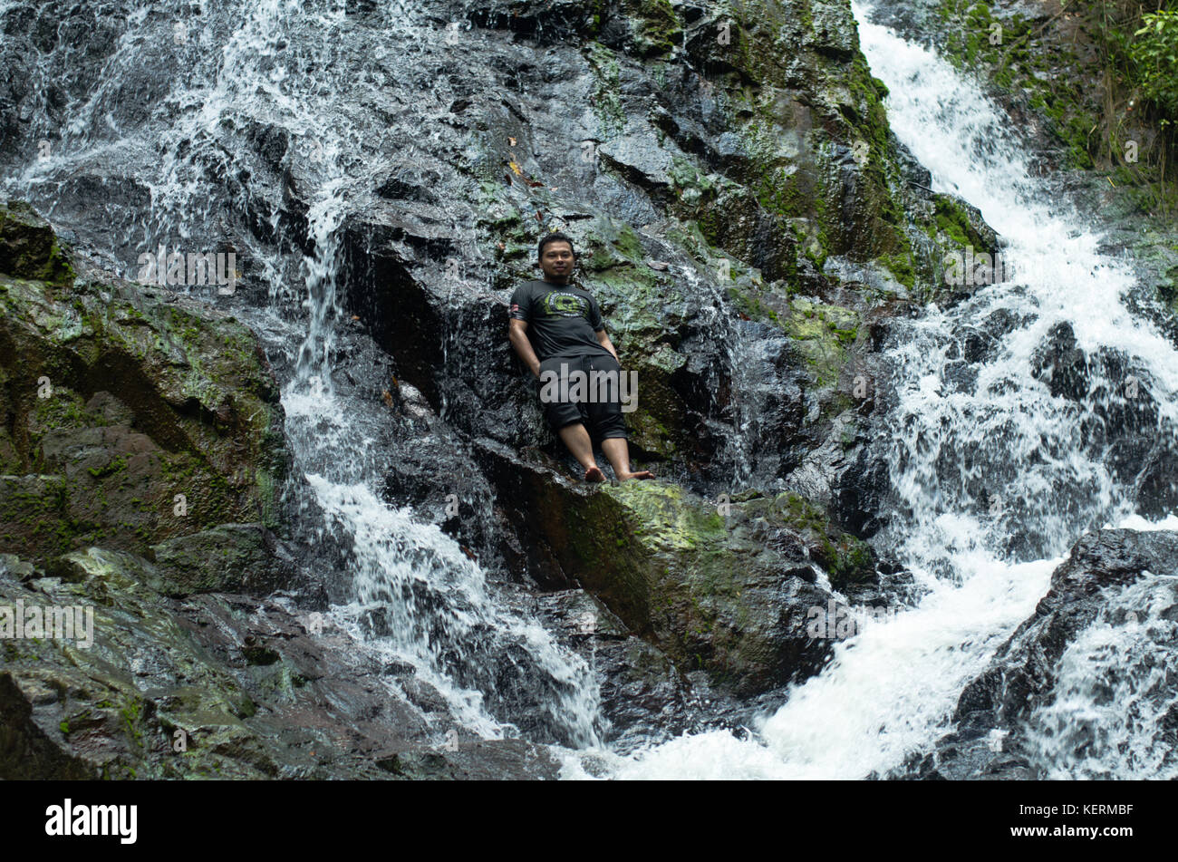 Man sitting waterfall enjoying nature hi-res stock photography and ...