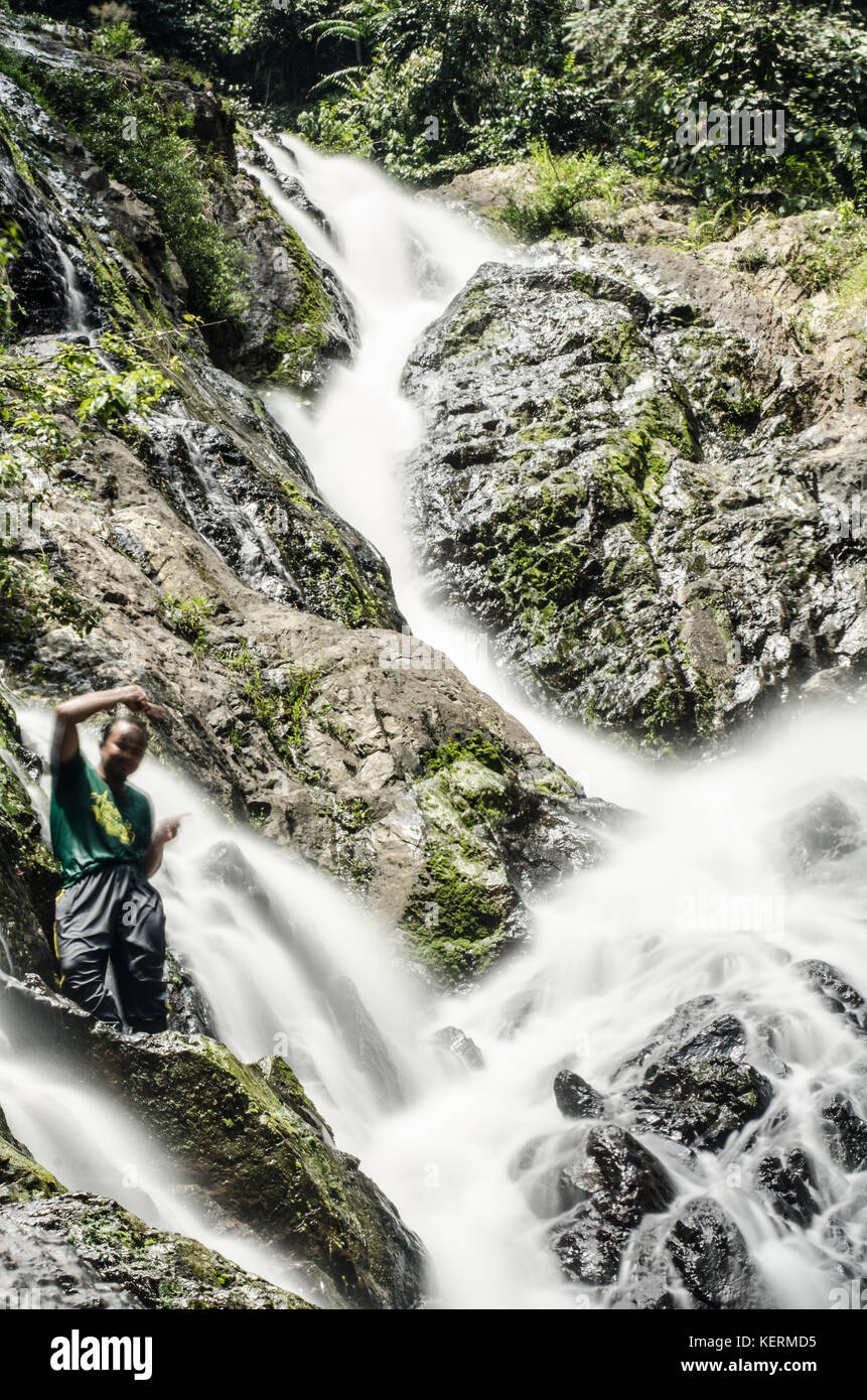 A guy taking his time at waterfall Stock Photo - Alamy