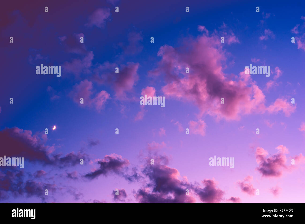 Pink Clouds in a blue sky with a touch of moon Stock Photo - Alamy