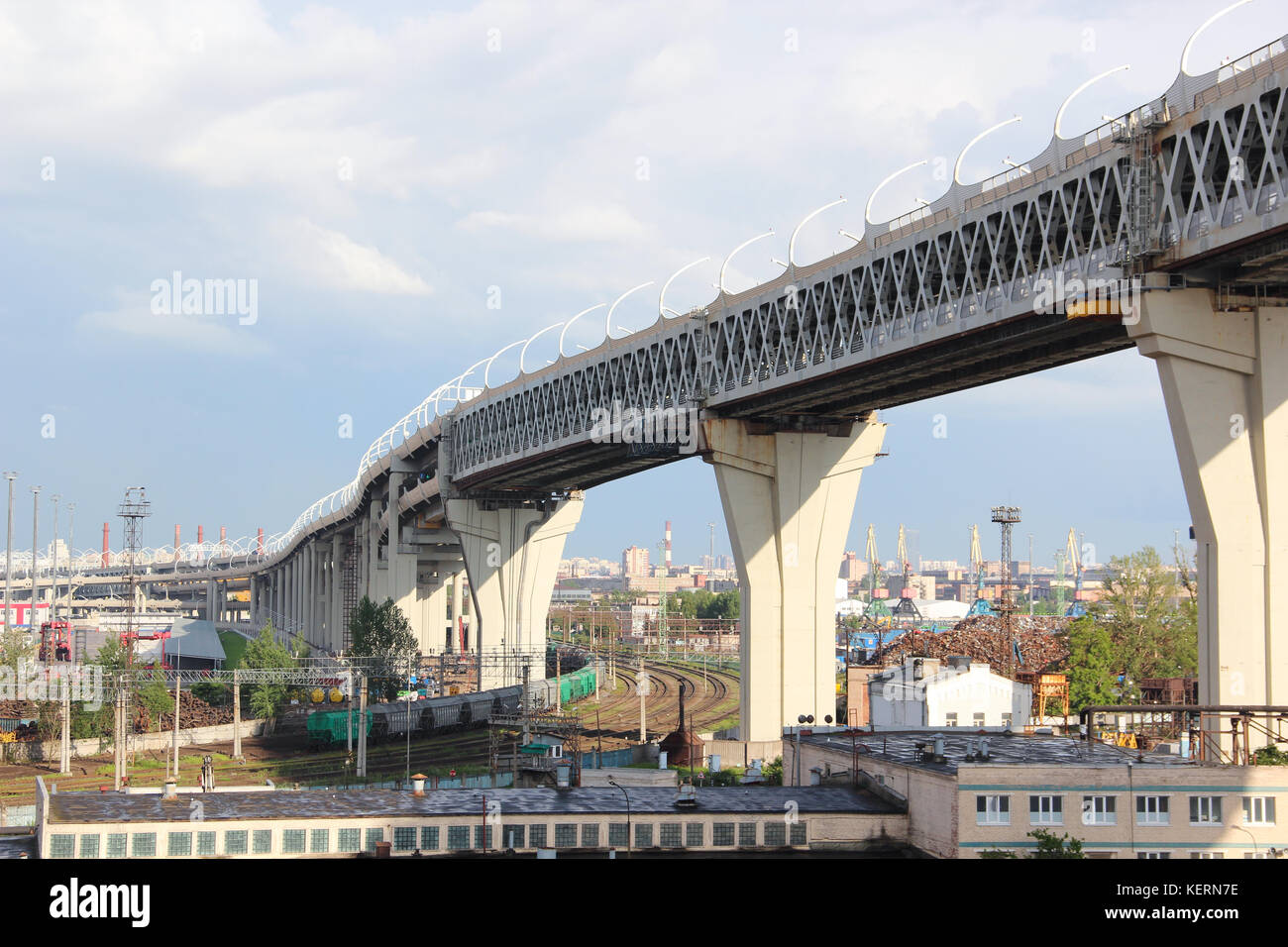 Bridge over industrial area trade port with railway wagons with cranes ...