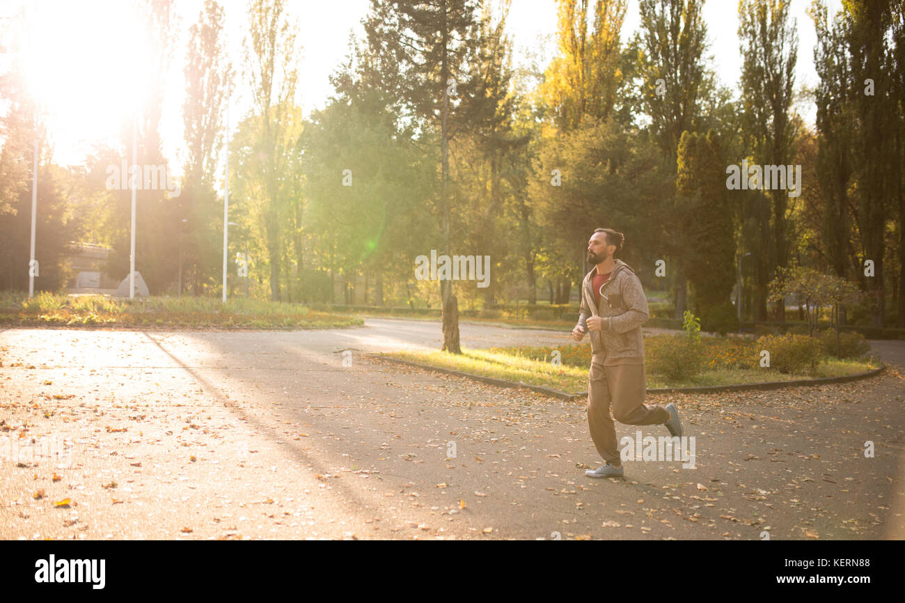Man running in morning sunshine Stock Photo - Alamy