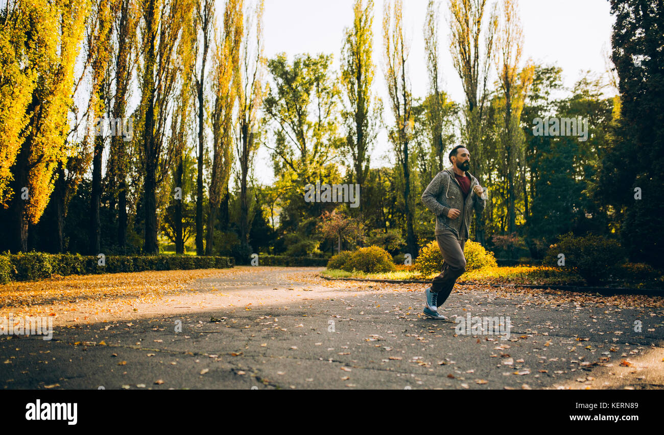 Man running in morning sunshine Stock Photo - Alamy
