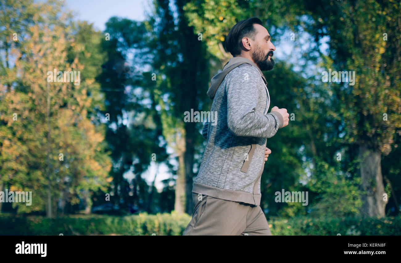 Jogging man in nature Stock Photo - Alamy