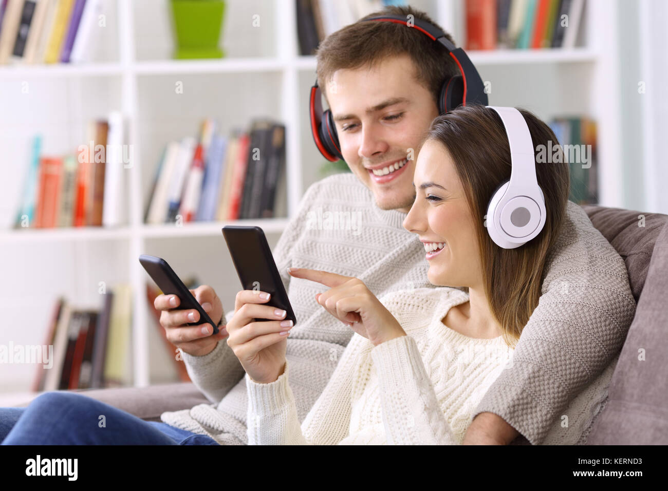 Couple sharing headphones hi-res stock photography and images - Alamy