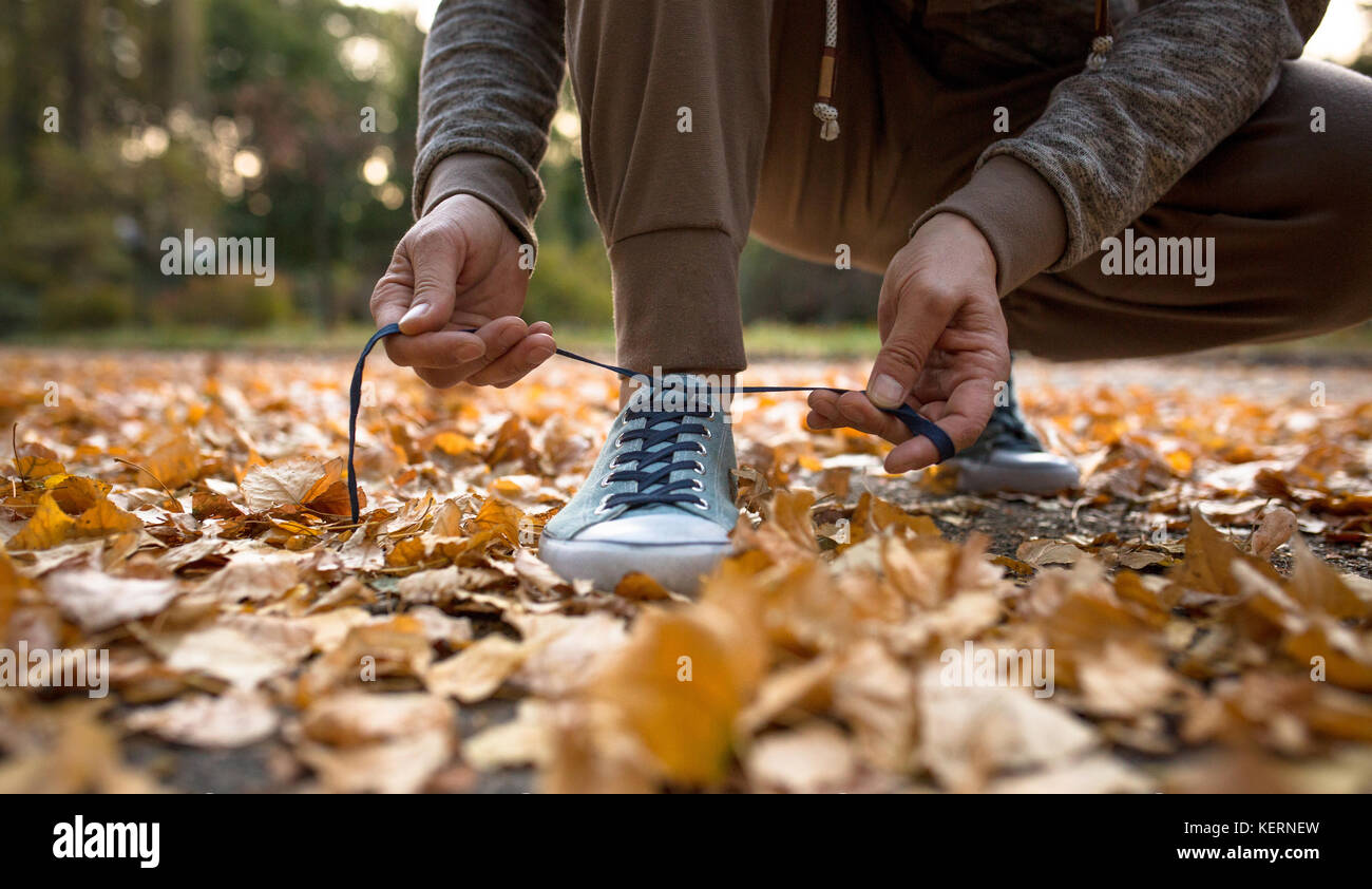 Man getting ready for running lacing sport shoes Stock Photo - Alamy