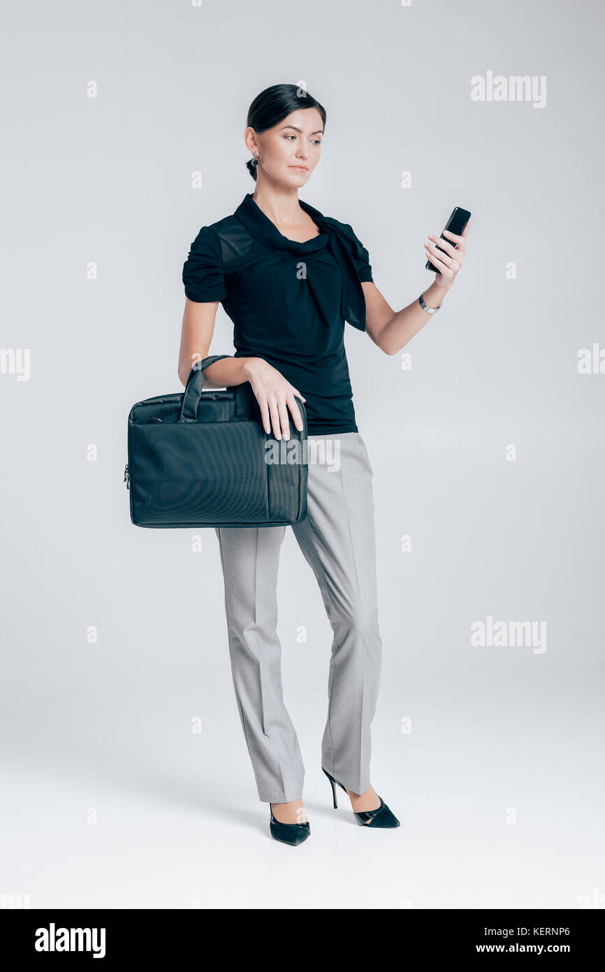 attractive business woman on gray background Stock Photo - Alamy