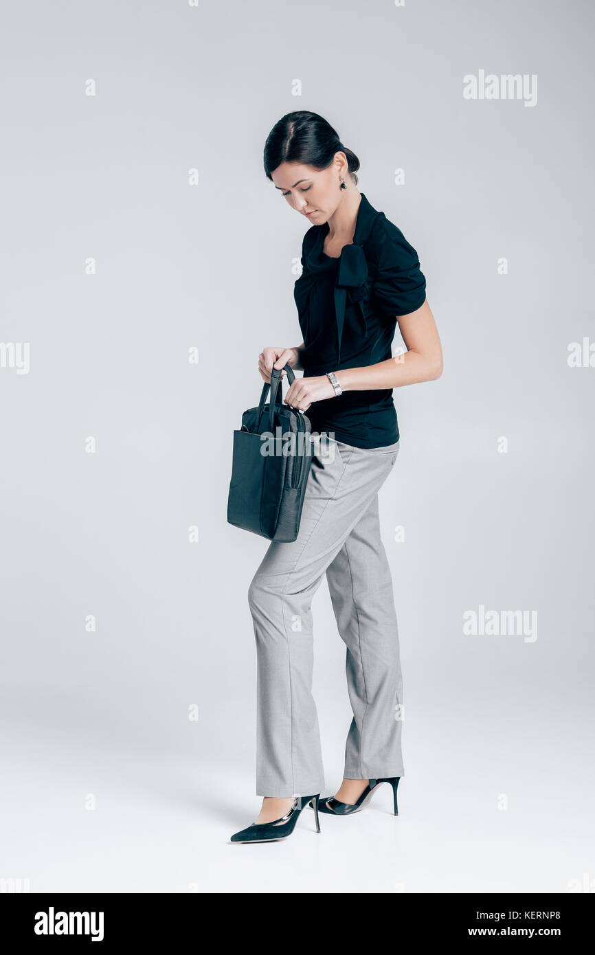 attractive business woman on gray background Stock Photo - Alamy