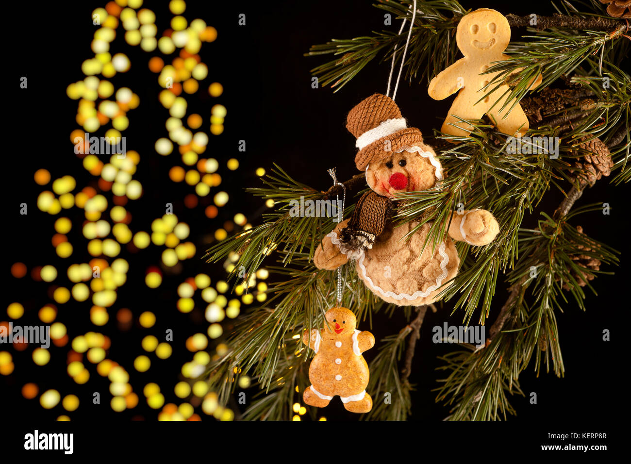 Real and fake gingerbread men hanging in a christmas tree Stock Photo ...
