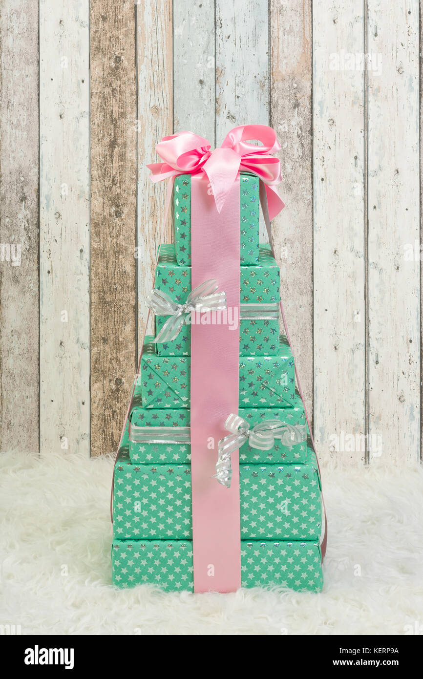 Stack of six christmas presents wrapped in a pink bow Stock Photo - Alamy