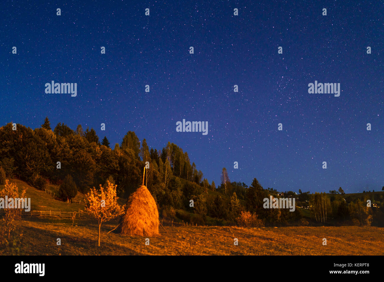 night landscape with haystack in the mountains Stock Photo - Alamy