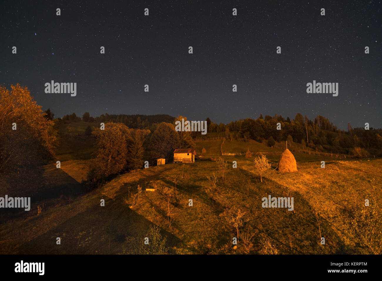 night landscape with haystack in the mountains Stock Photo - Alamy