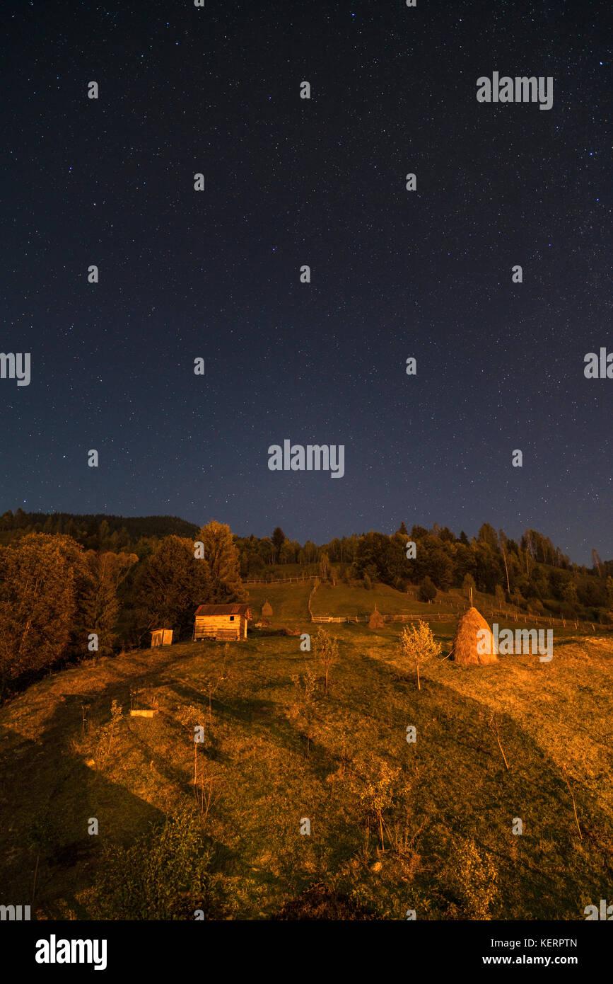 night landscape with haystack in the mountains Stock Photo - Alamy