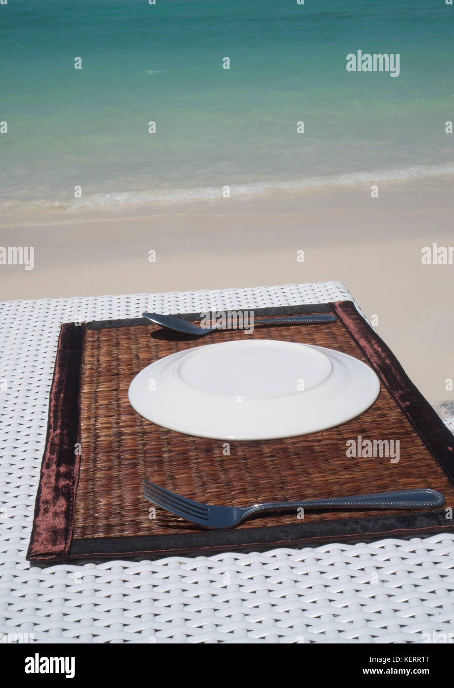 Table setting at the beach restaurant with beautiful blue sea ...