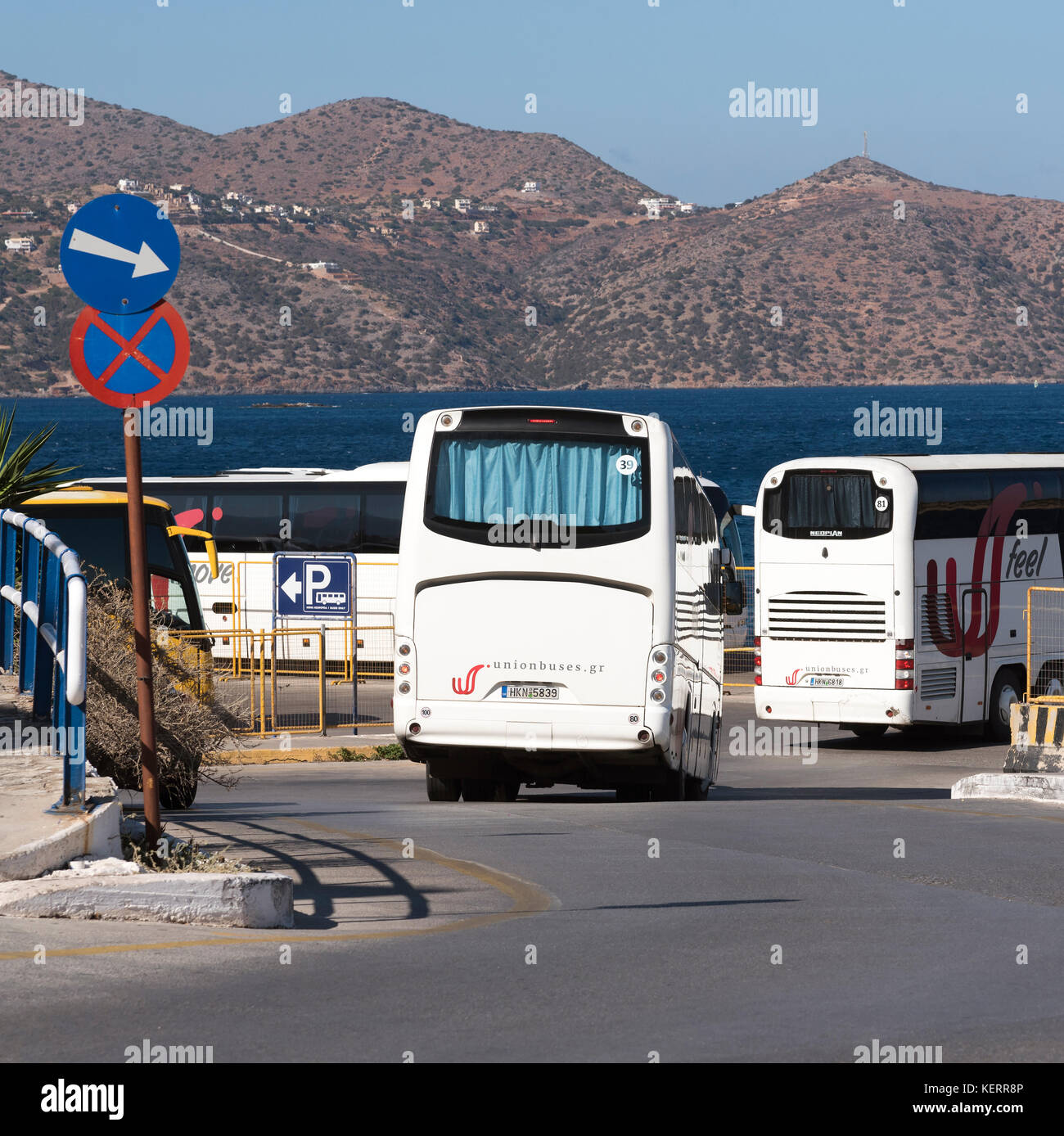 Agios Nikolaos, Crete, Greece. Bus and touist coach park on the harbour ...