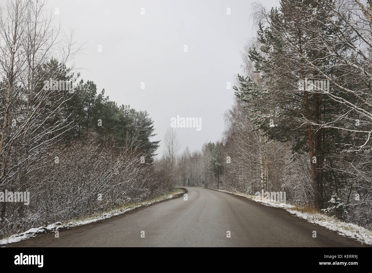 Paved road with the first snow on the roadside Stock Photo - Alamy