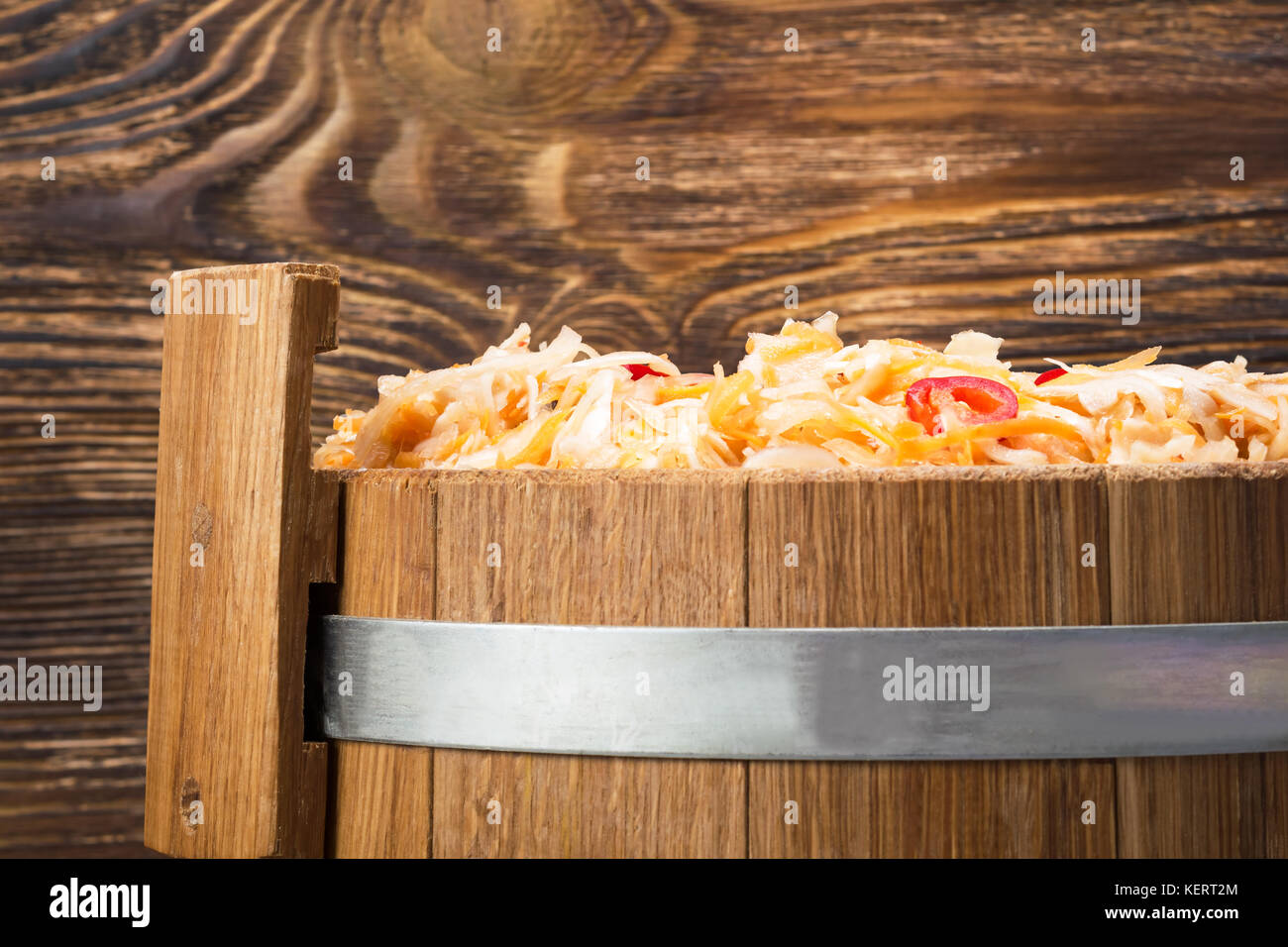 Salted cabbage with carrots lie in an oak barrel Stock Photo - Alamy