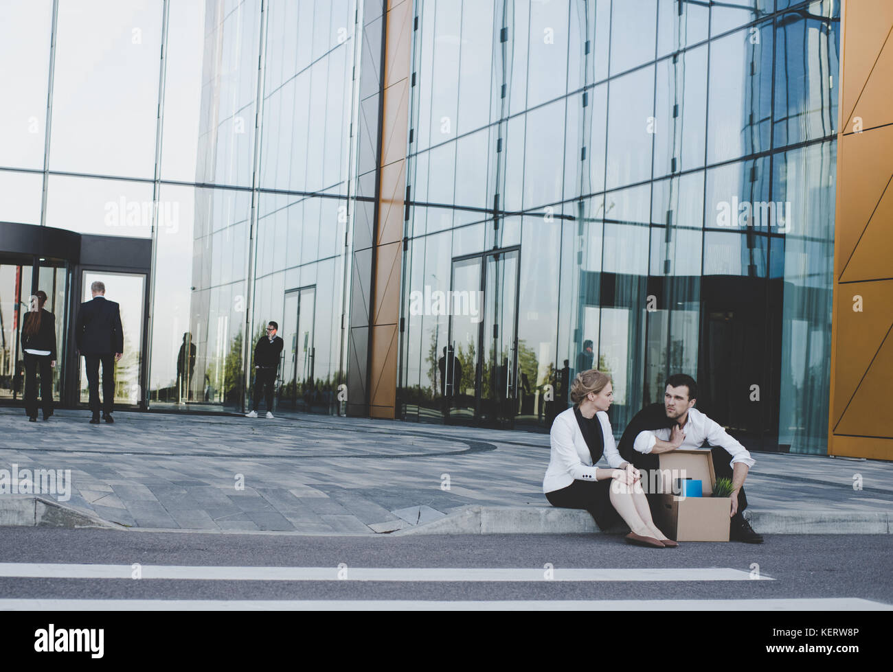Fired business man sitting frustrated and upset on the street near ...