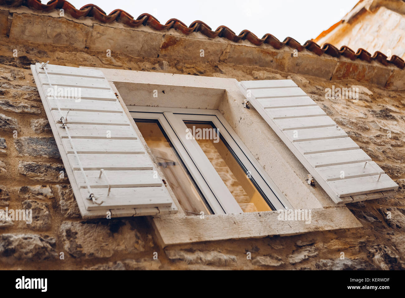 window with white shutters at sunset Stock Photo - Alamy