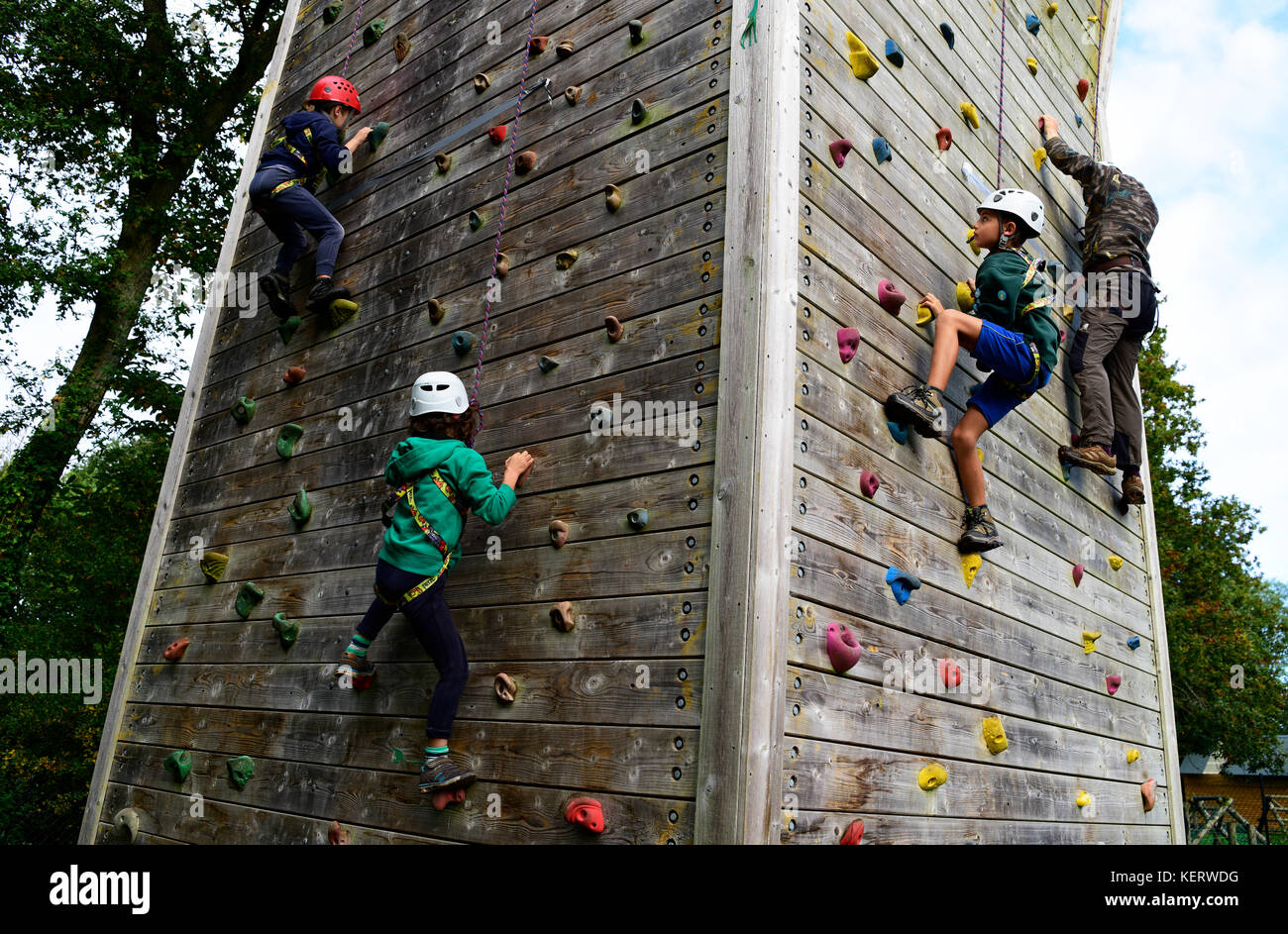 Youngsters and adult using climbing wall to help raise money for a new ...