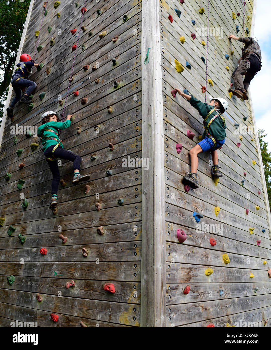Youngsters and adult using climbing wall to help raise money for a new ...