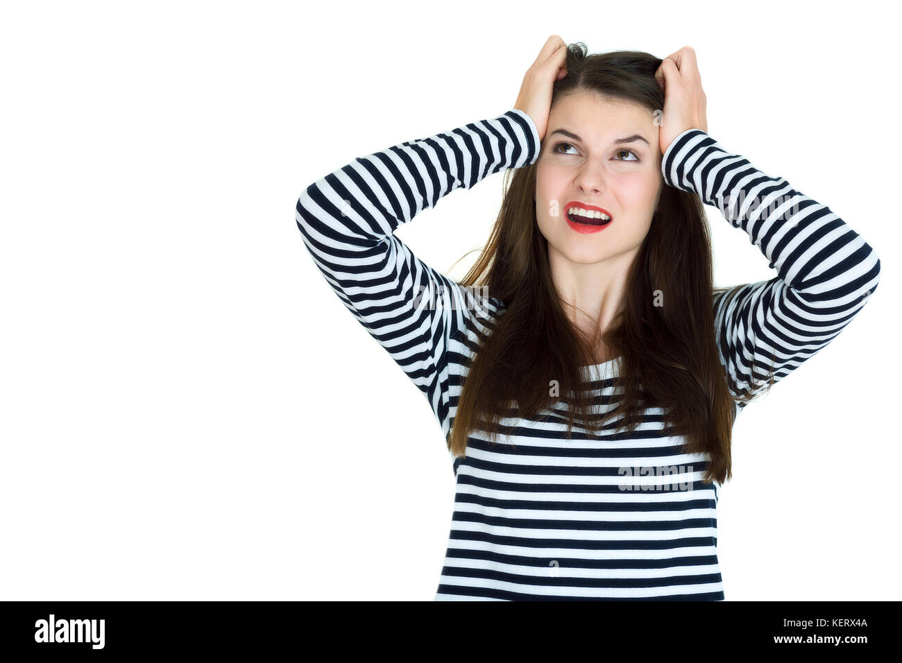 Portrait of a frustrated angry woman screaming out loud and pulling her ...