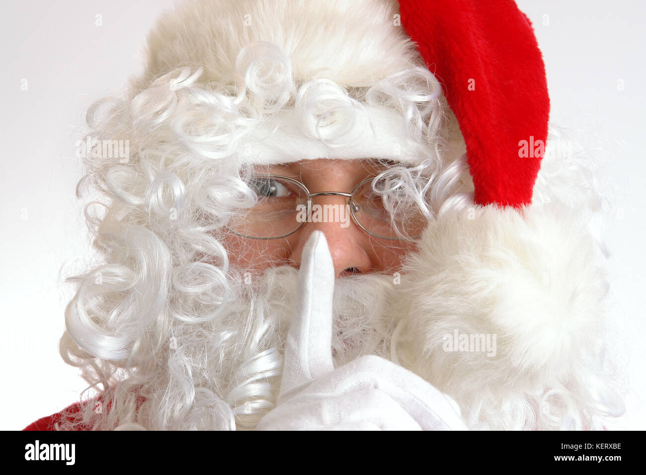 Closeup of Santa Clause hushing with index finger put to his mouth ...