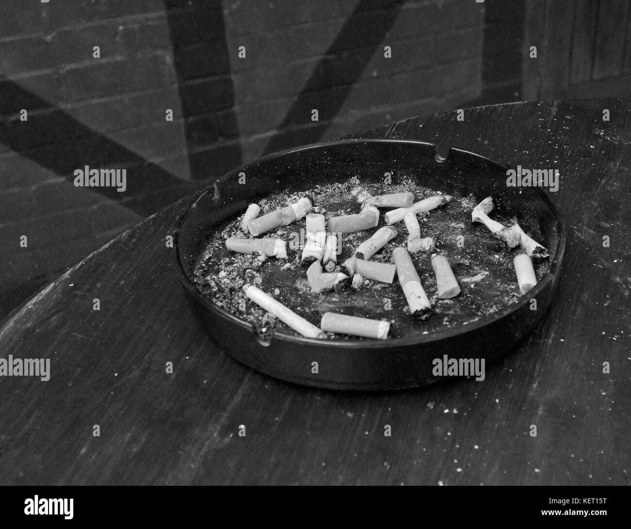 a dirty ashtrey outside a dingy pub Stock Photo - Alamy