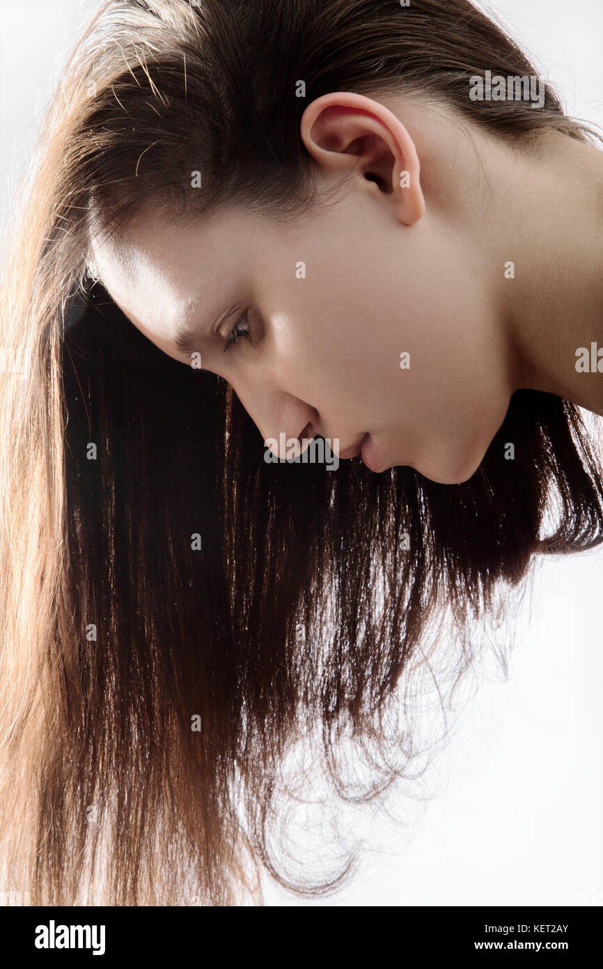 sad female profile with long hair on white background Stock Photo - Alamy