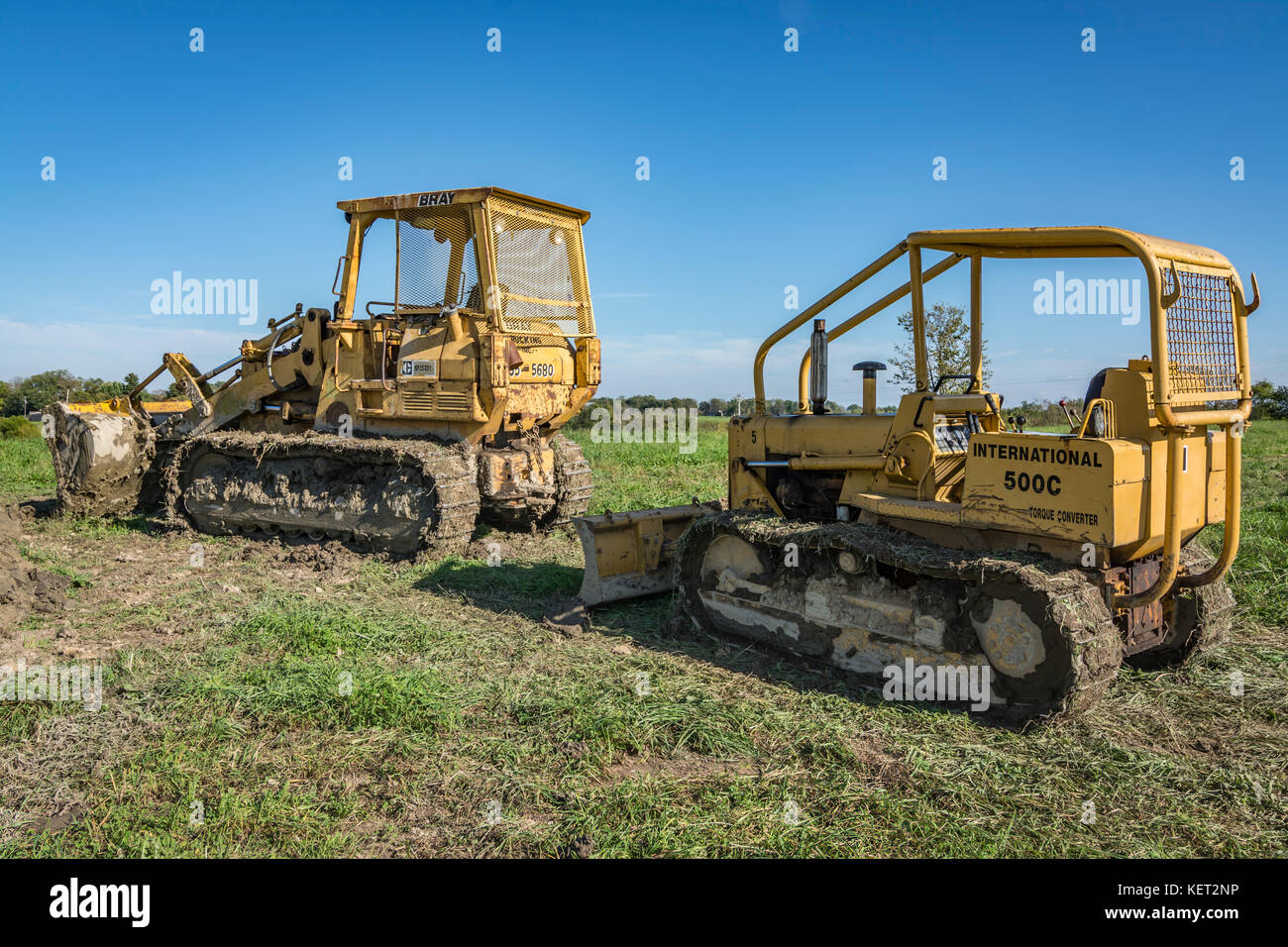 Parked heavy equipment bulldozer and loader Stock Photo - Alamy
