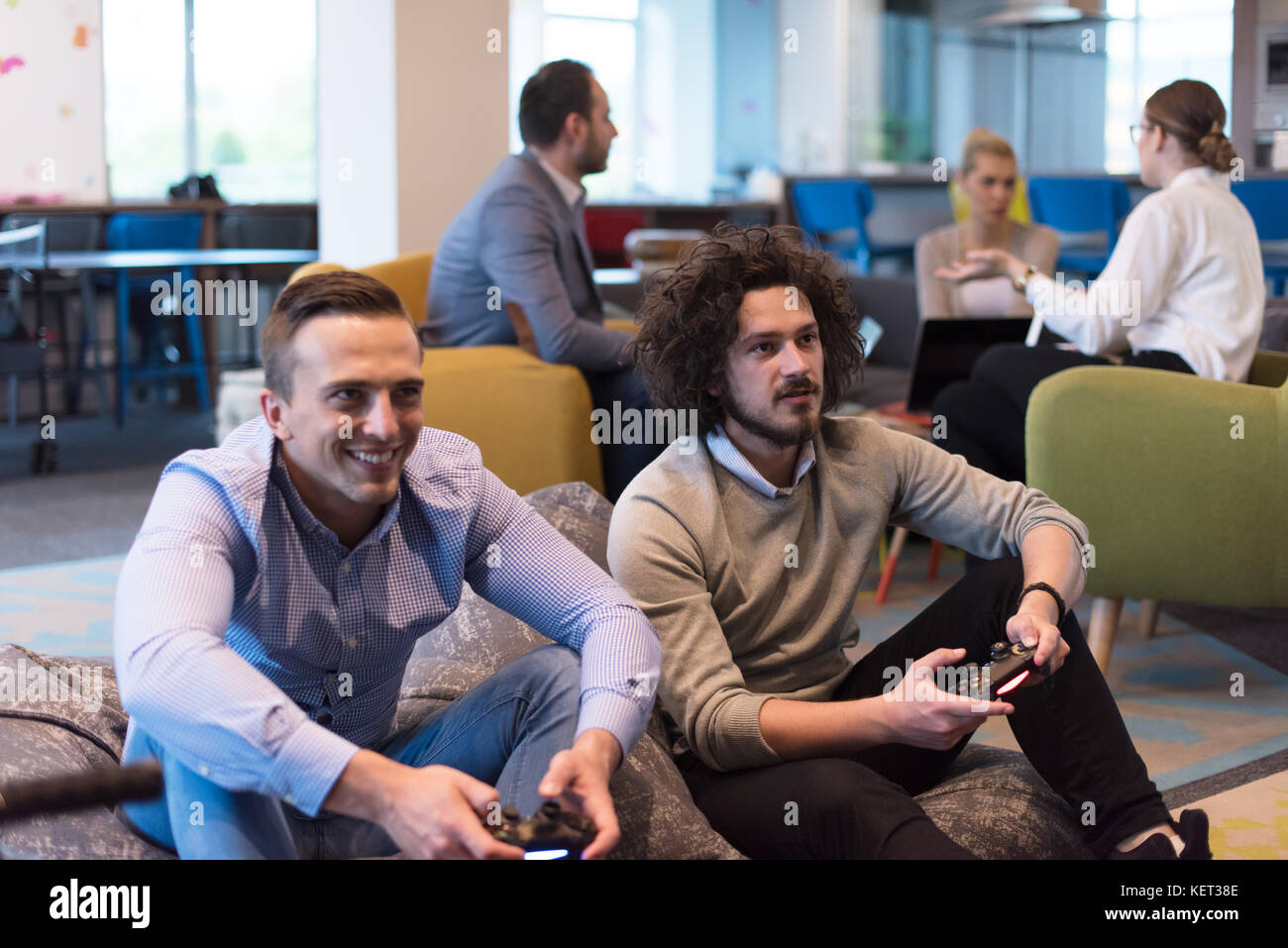 Work hard play hard. Workers Playing computer games in creative startup ...