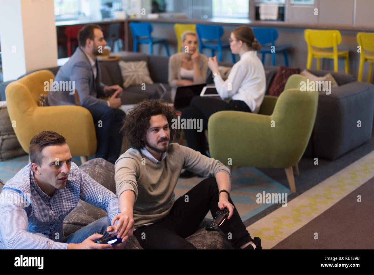 Work hard play hard. Workers Playing computer games in creative startup ...