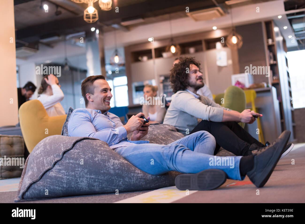 Work hard play hard. Workers Playing computer games in creative startup ...