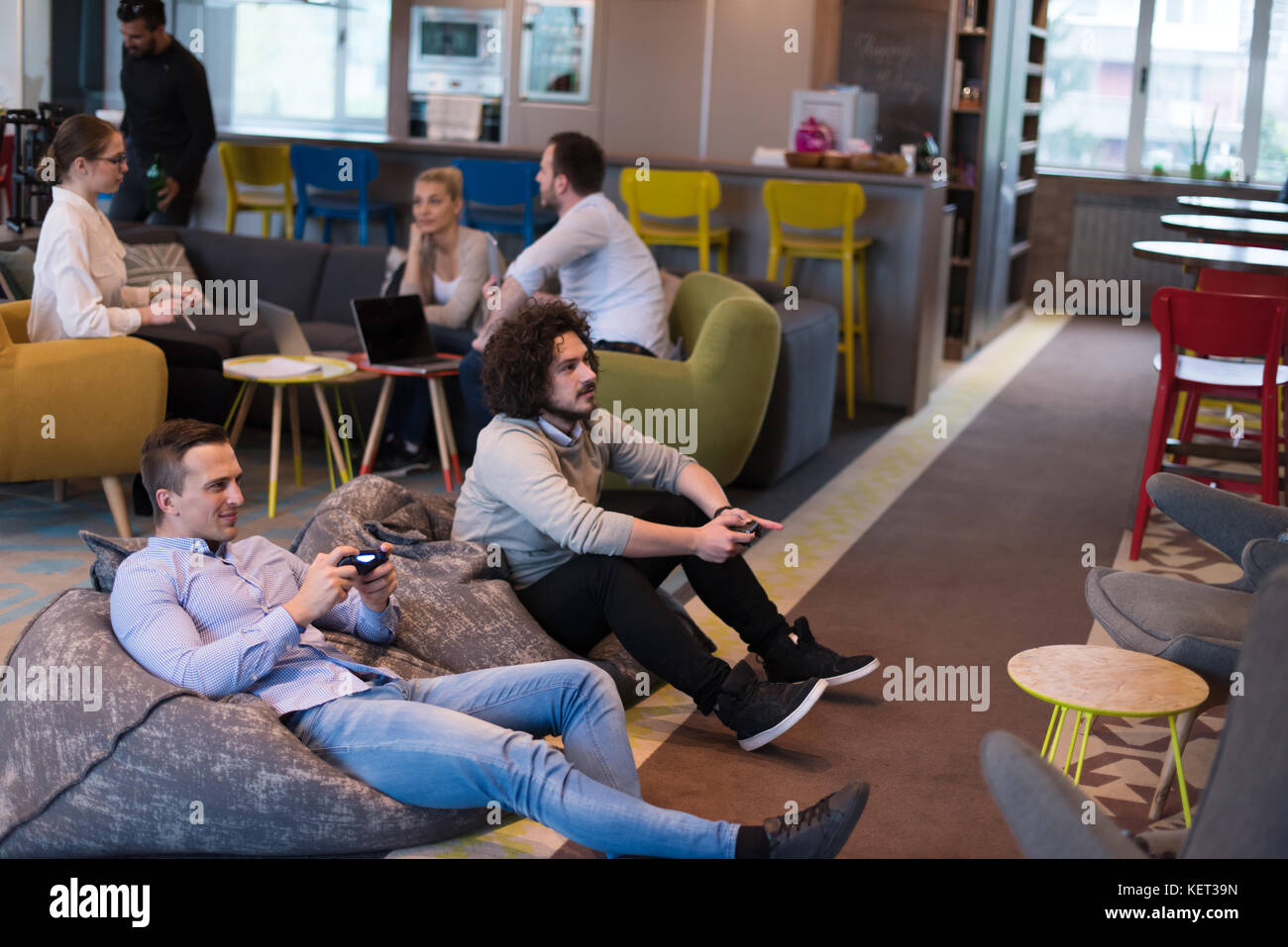Work hard play hard. Workers Playing computer games in creative startup ...